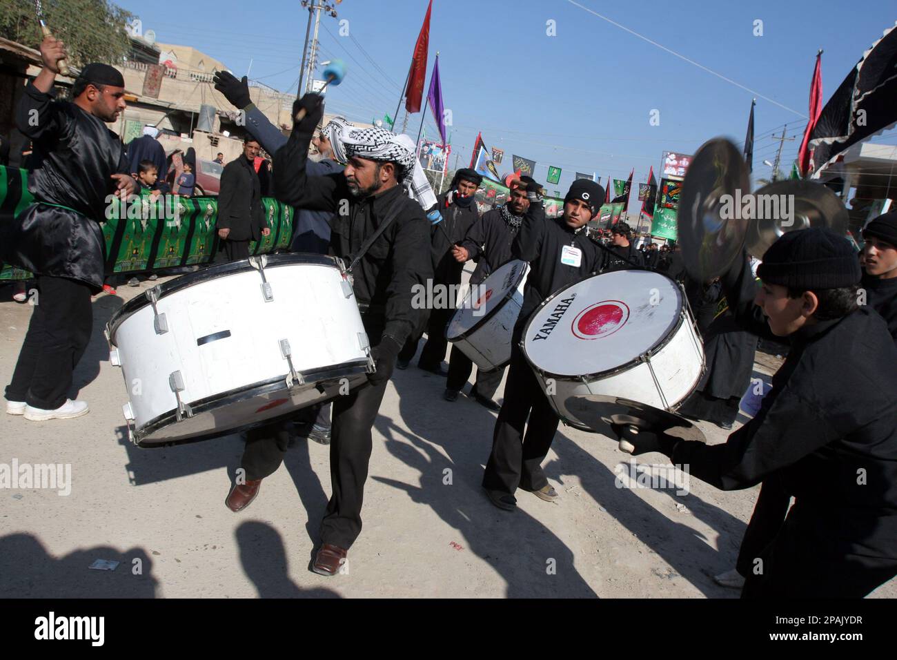 Iraqis participate in a procession marking the Festival of Muharram in ...