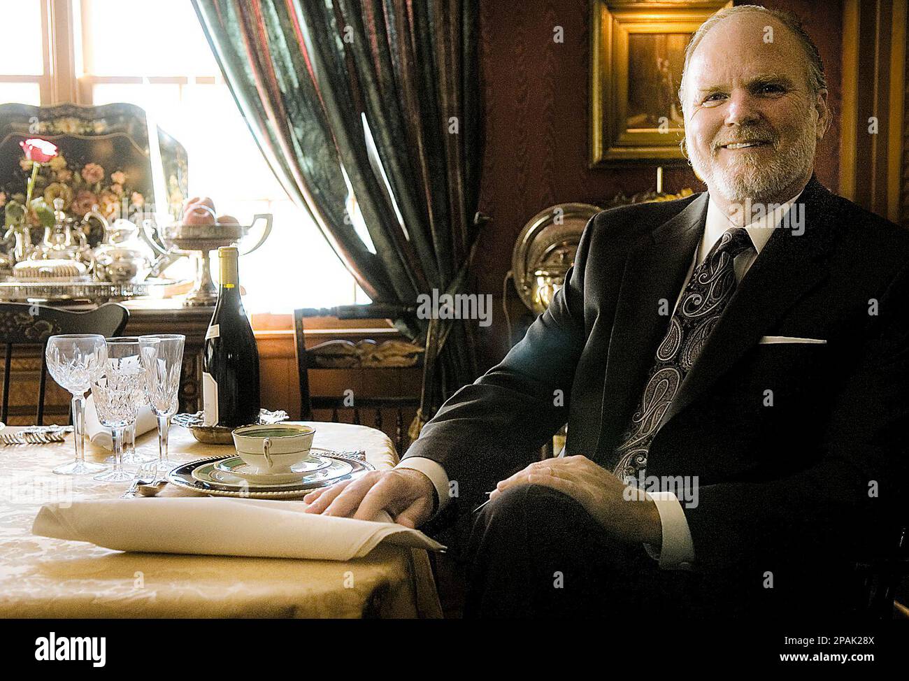 Ken Upton, owner of Ken's Creative Kitchen, sits at his dining room ...