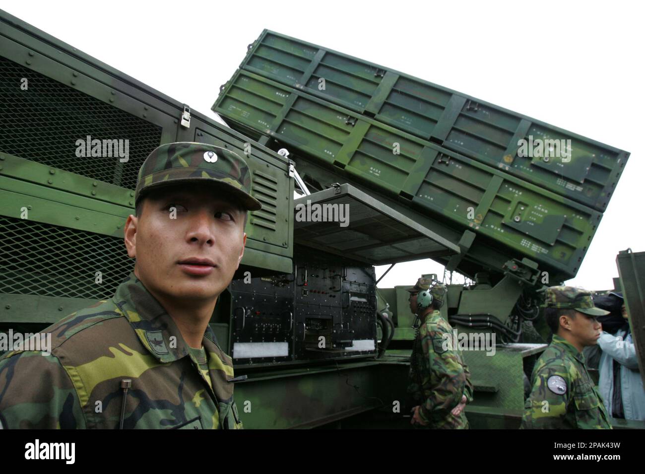 Taiwanese soldiers stand at attention in front of an indigenous "Tien ...
