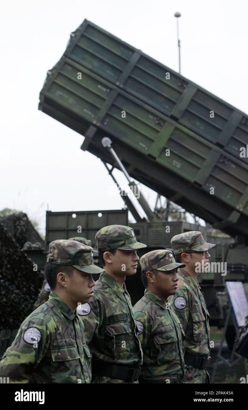 Taiwanese soldiers stand at attention in front of an indigenous "Tien ...