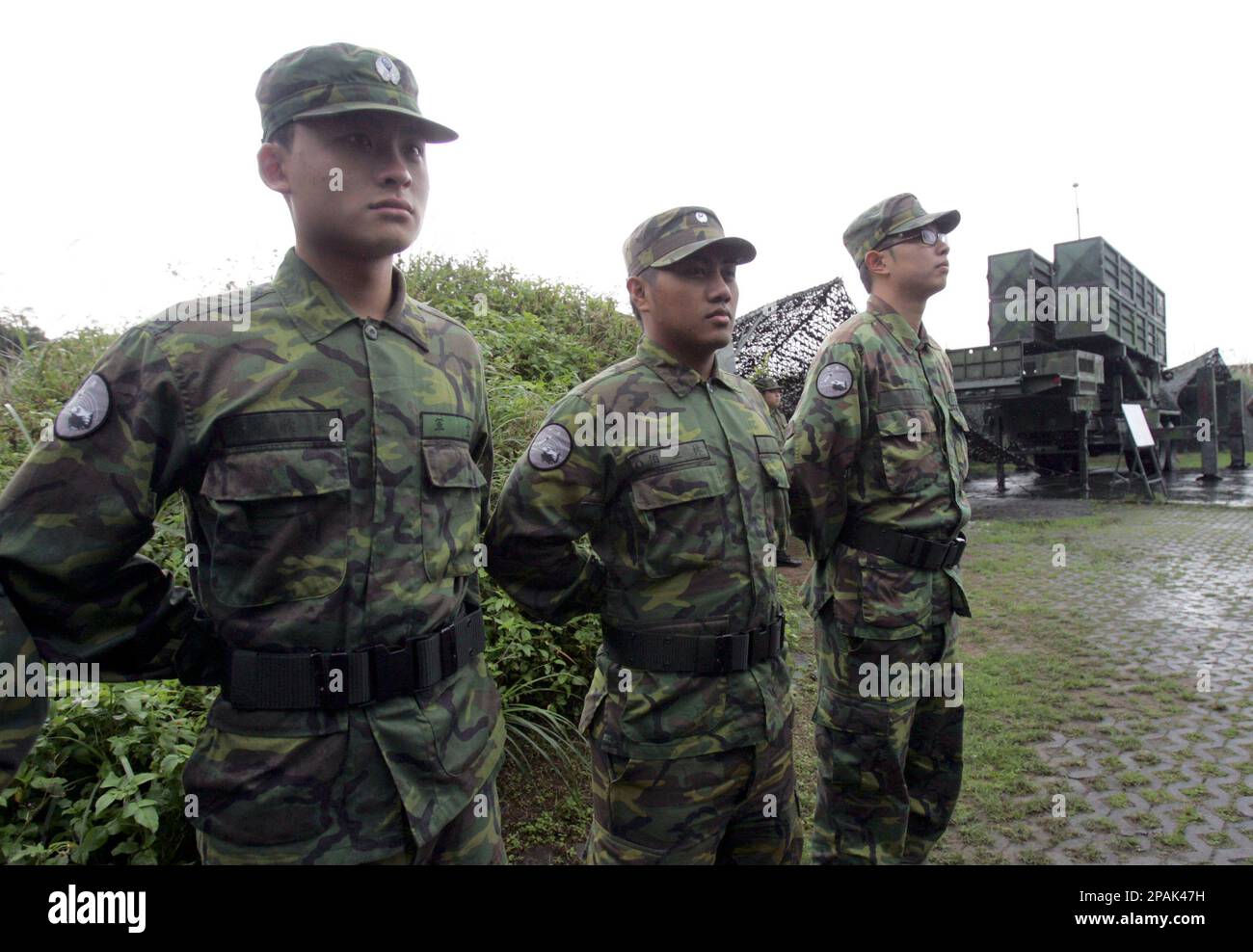 Taiwanese soldiers stand at attention in front of an indigenous "Tien ...