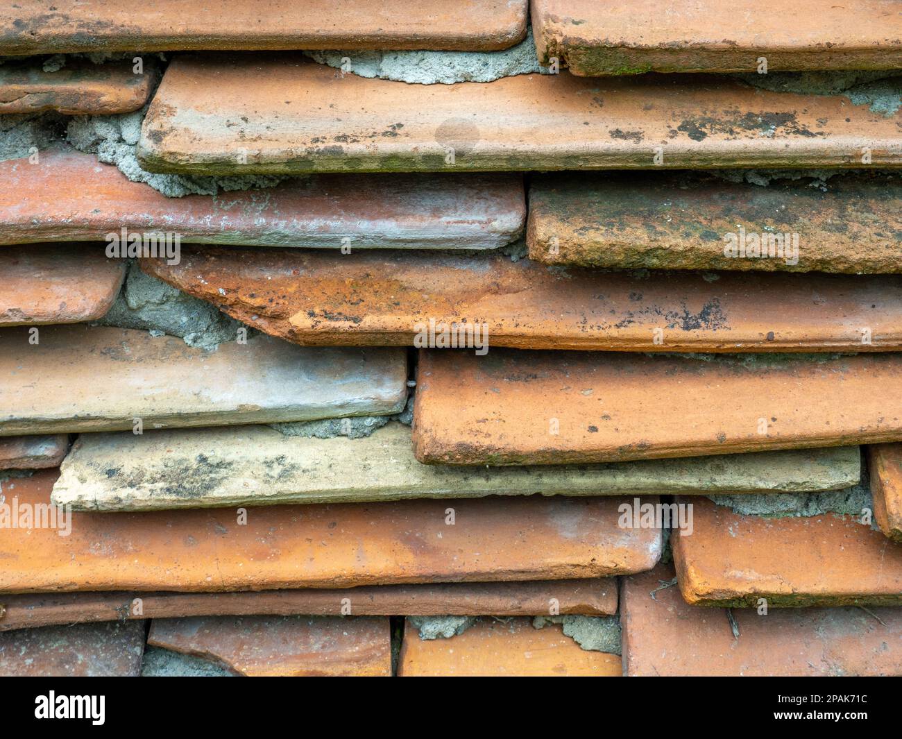 Background from the old tiled masonry. Orange tiles. Wall made of clay ...