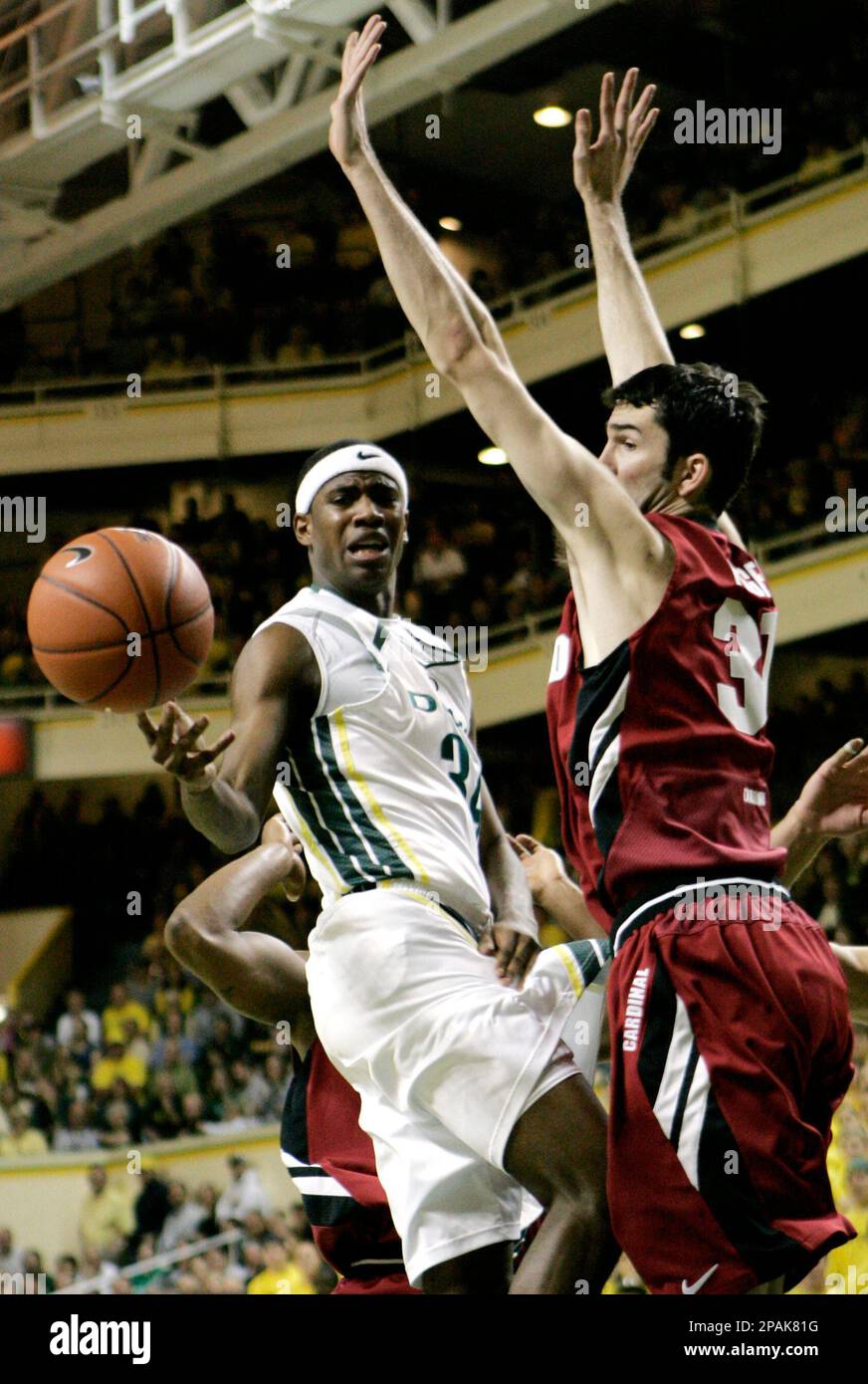 Oregon guard Tajuan Porter, left, passes off against Stanford forward ...