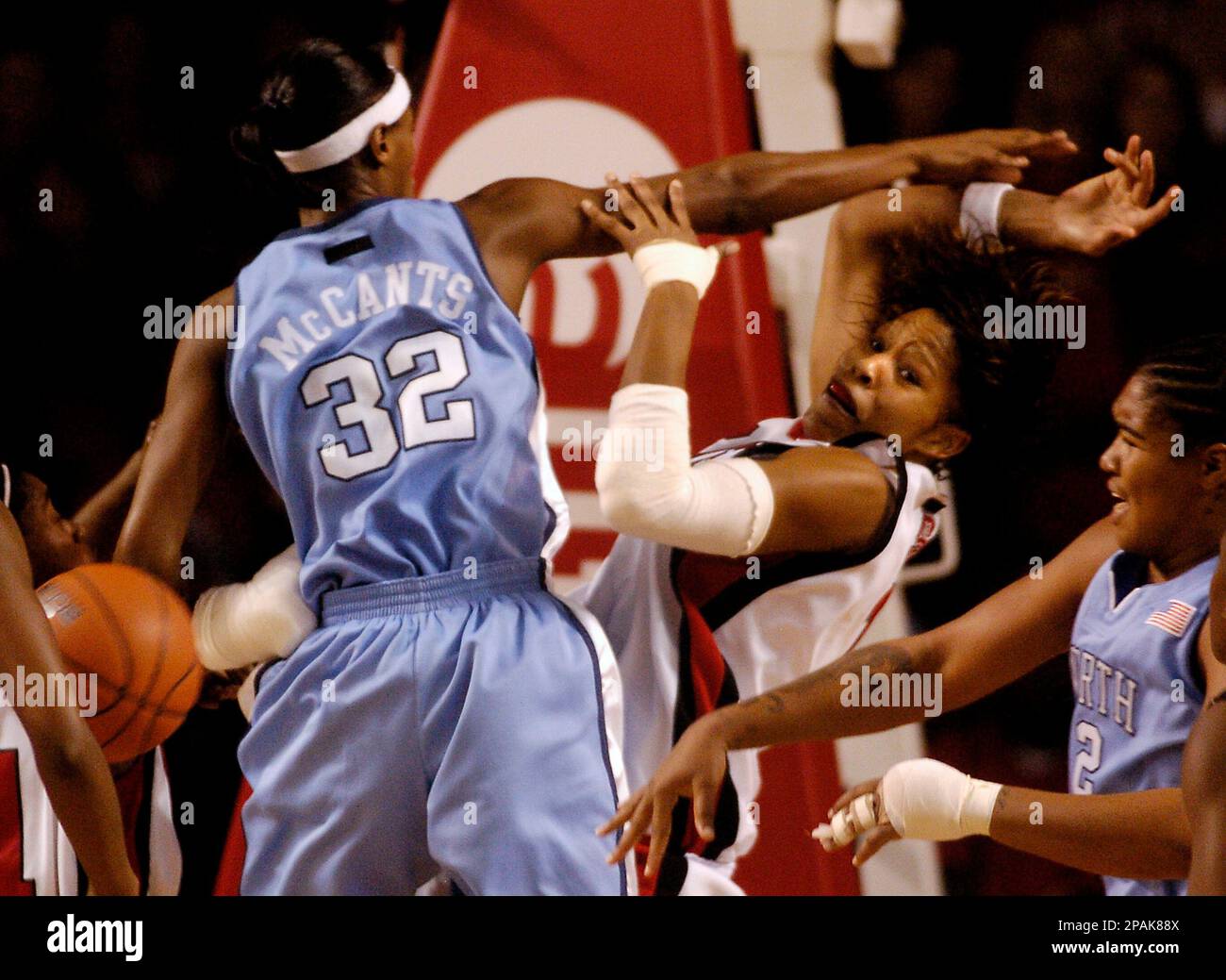 North Carolina State's Khadijah Whittington, center, is knocked by ...