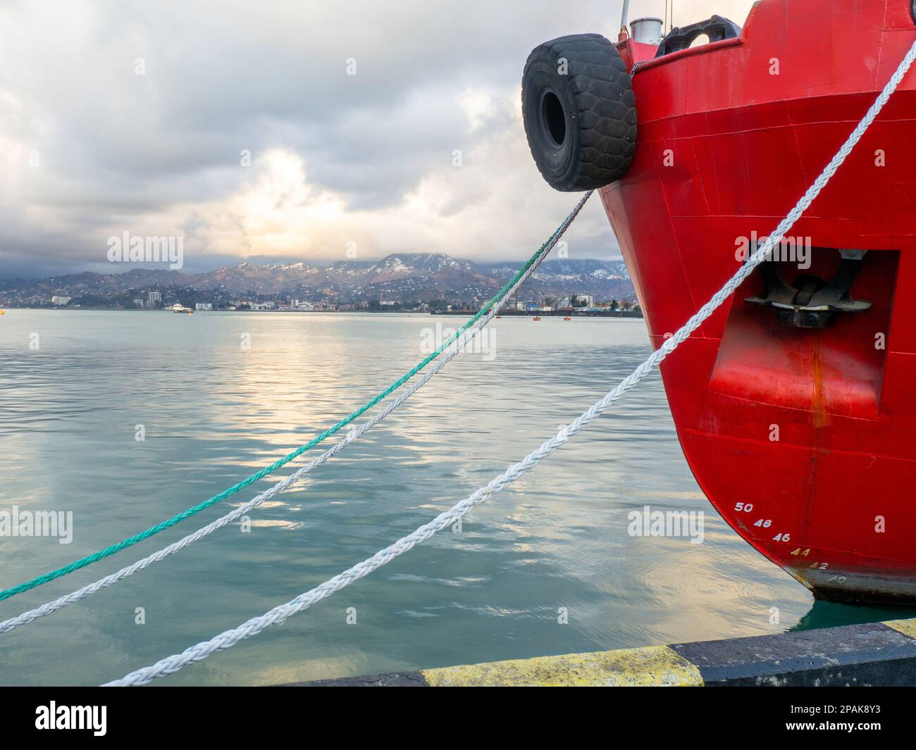 nose of the ship is red. Tire on the bow of the ship. Safety . Moored ...
