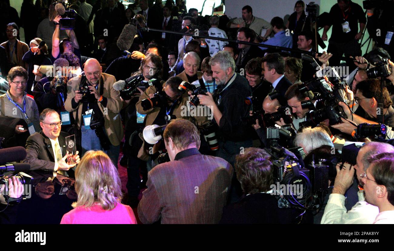 Ed Peper, general manager of Chevrolet, left, poses poses with the 2008 ...