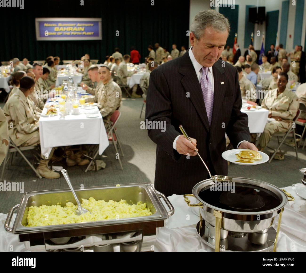 U.S. President George W. Bush serves himself as he has breakfast with ...