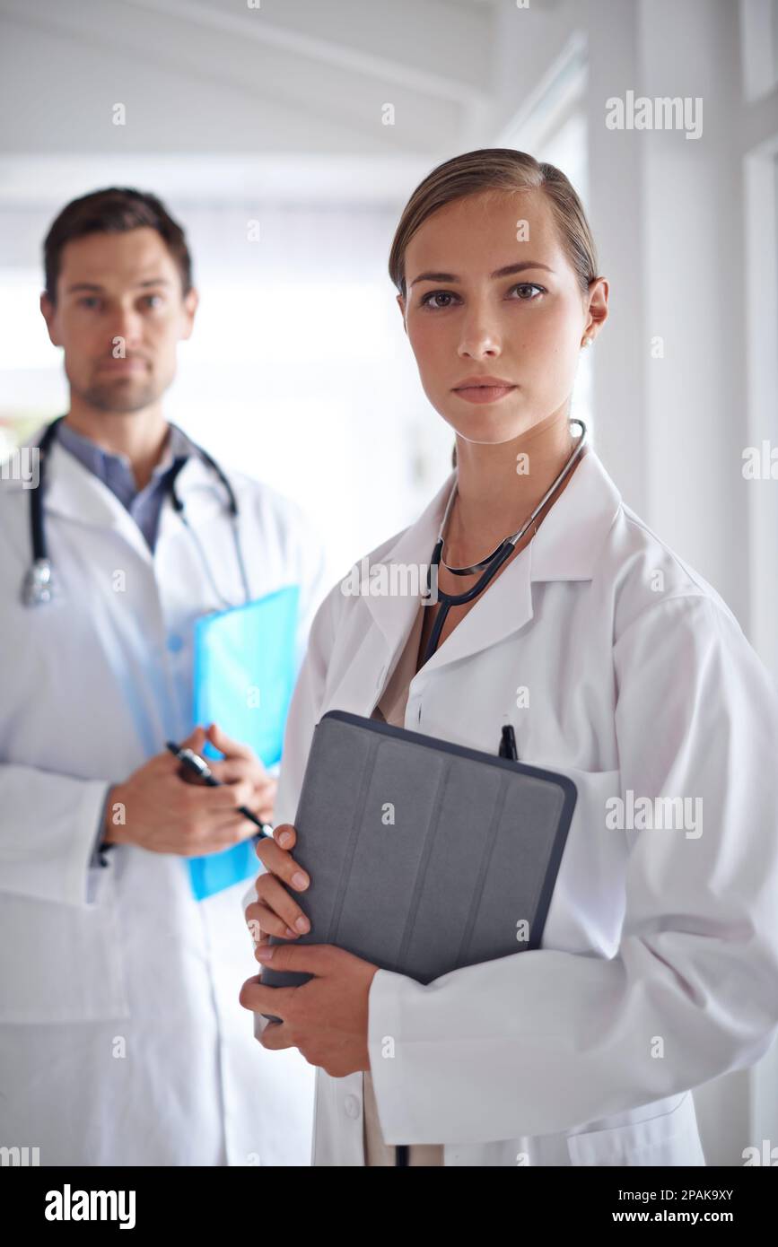 Your medical team. Portrait of two young doctors standing in a hospital corridor Stock Photo - Alamy