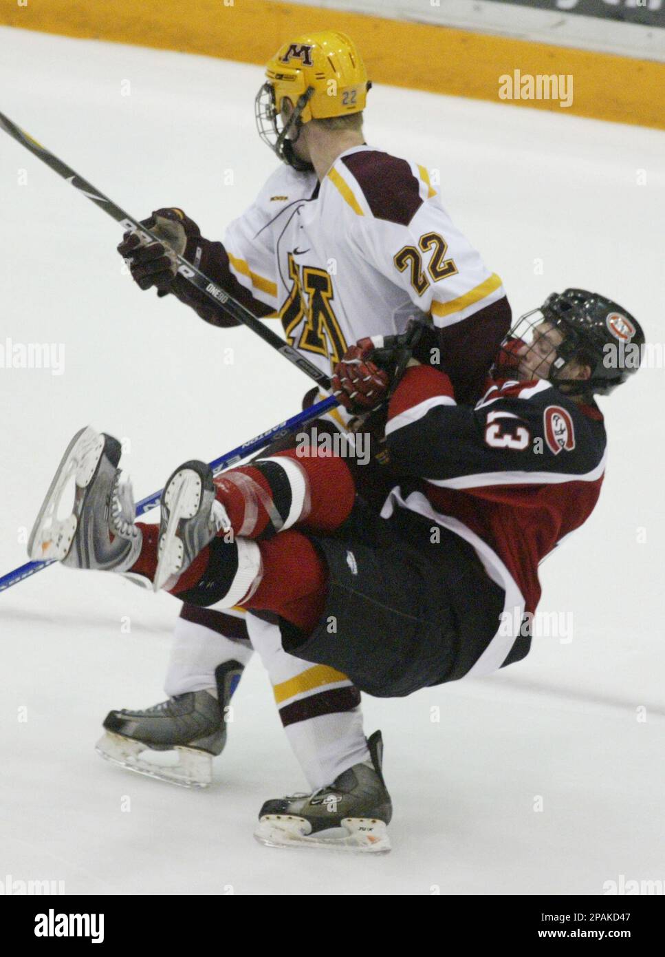 St. Cloud State center Nate Dey (13) looses his footing as he holds on ...