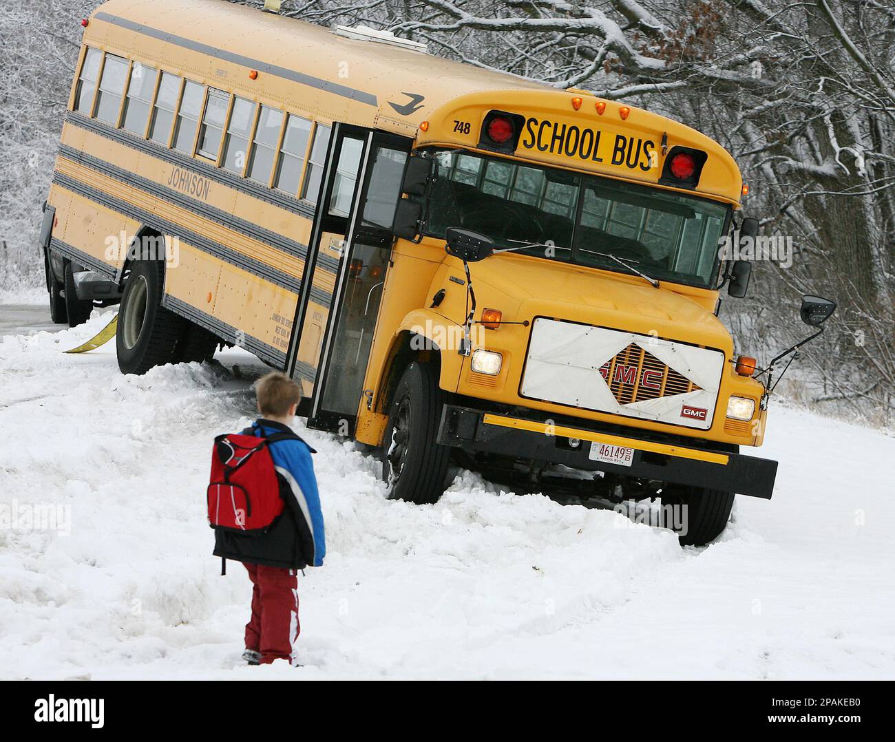 Dylan Engling, 5, checks out a school bus that slid into the ditch by ...