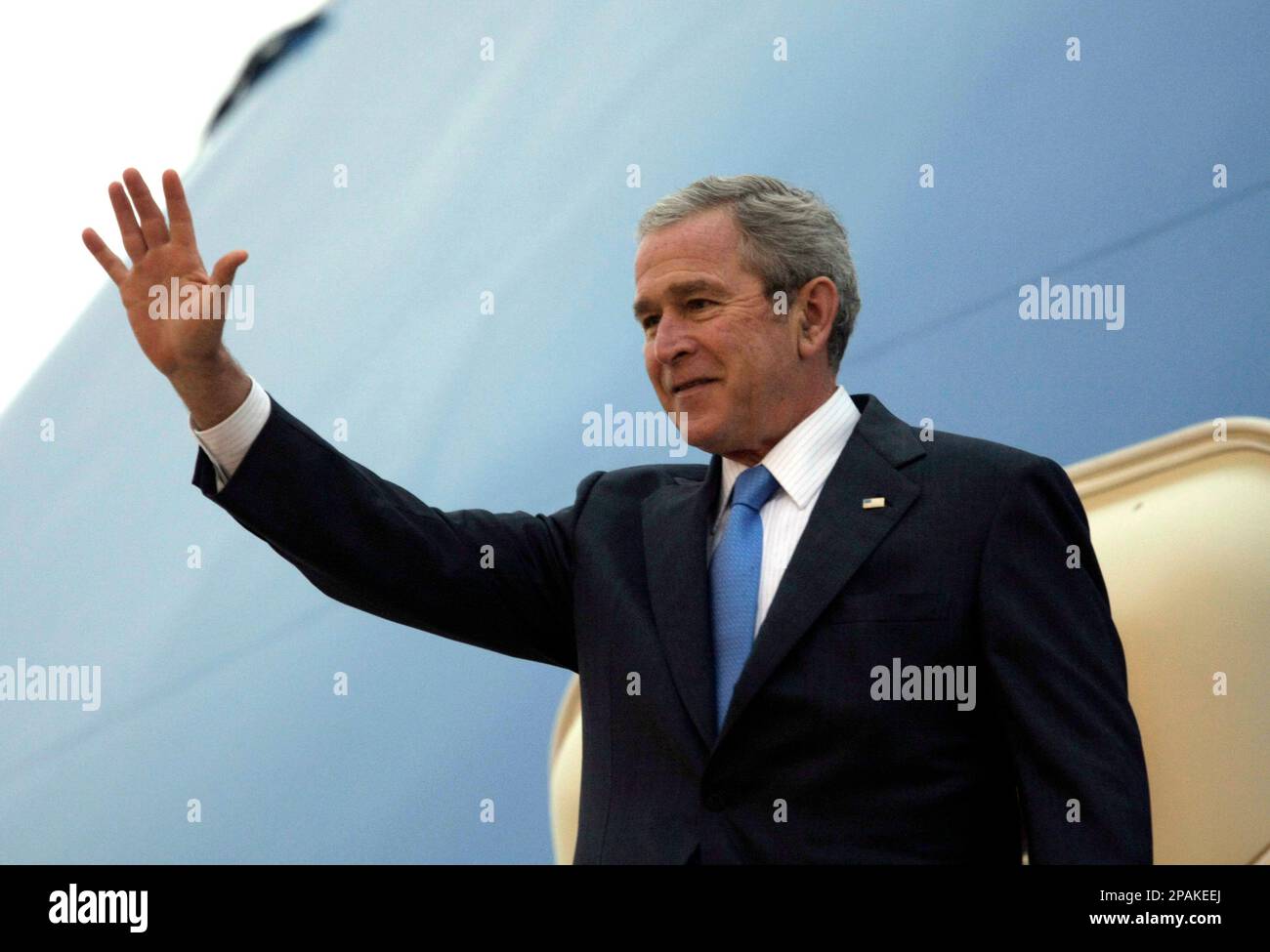 US President George W. Bush waves during his arrival at Kuwait ...