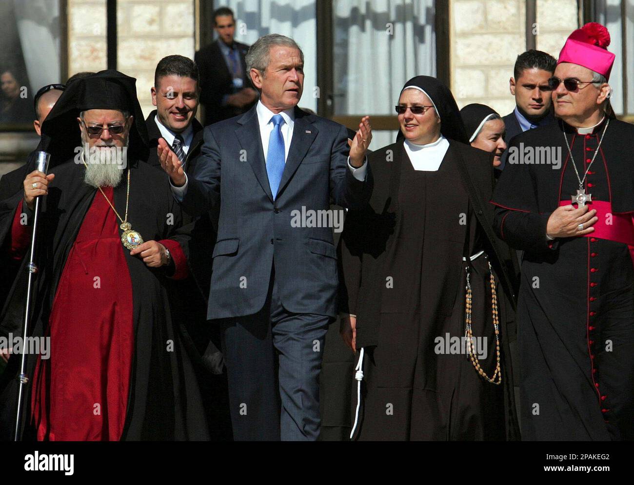 President Bush walks with Catholic priests and nuns during a visit to ...