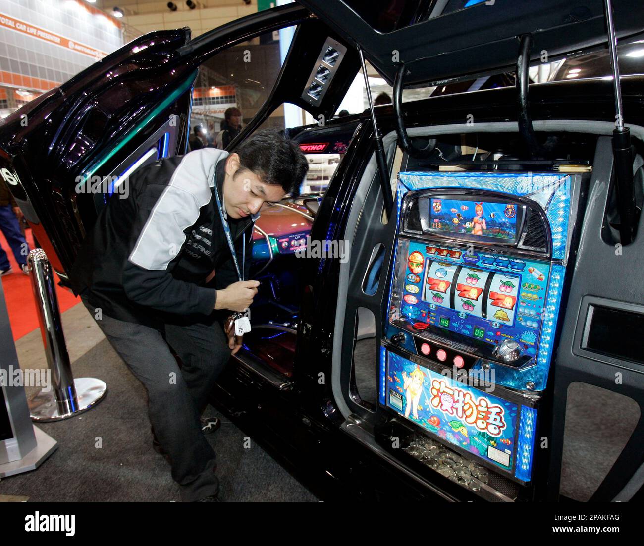 A staff of Japanese custom-made car maker Obayashi Factory ducks by a ...