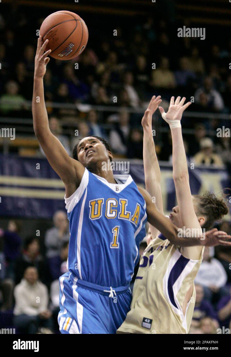UCLA's Nina Earl (1) drives past Washington's Katelan Redmon in the ...