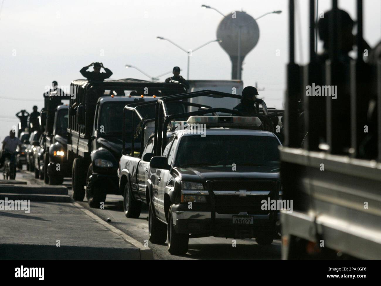 A convoy of Mexican Federal police stop while patrolling the border ...