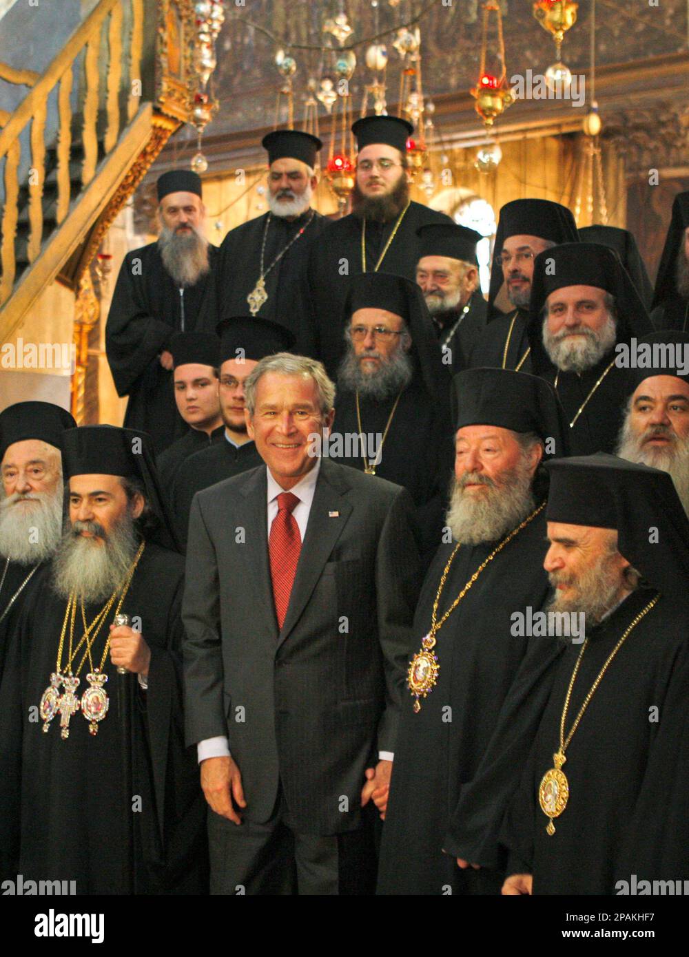 President George W. Bush stands with Greek Orthodox clergymen during a ...