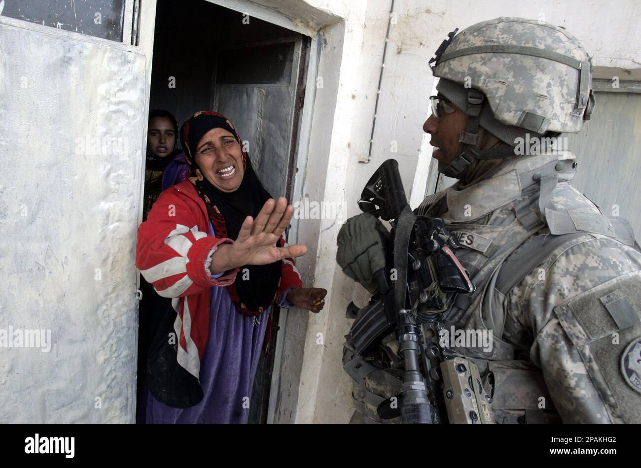 A woman cries as she talks to a U.S. army soldier from Ghostrider ...