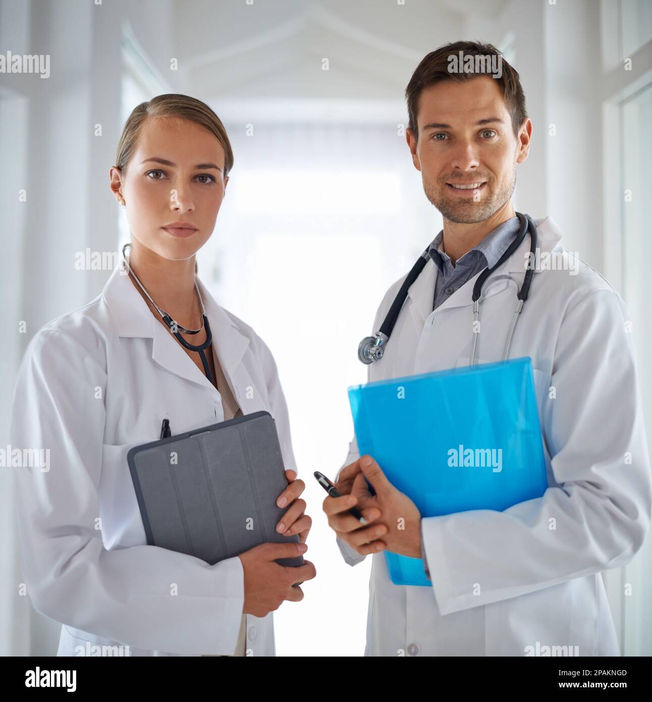 Team diagnosis. Portrait of two young doctors standing in a hospital ...