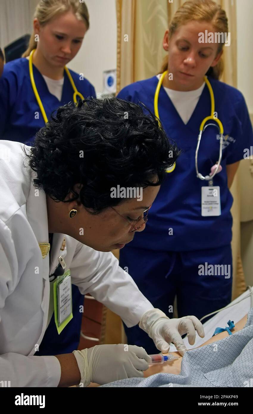 Sheila Jones, a clinical simulation facilitator, demonstrates to ...