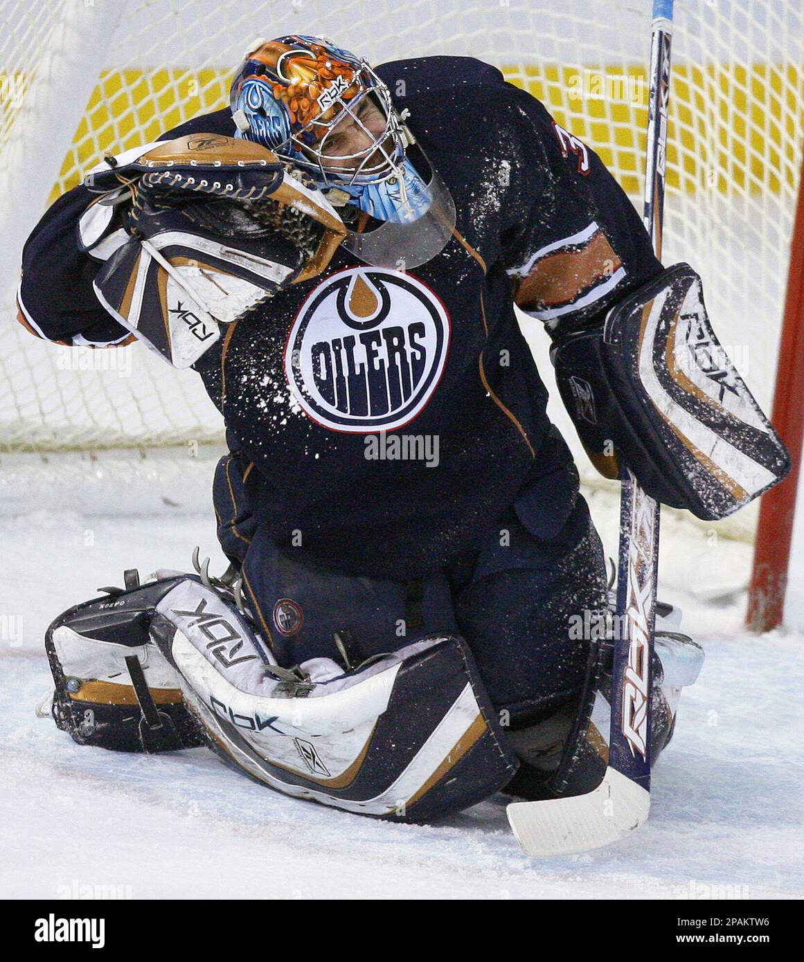 Edmonton Oilers goalie Mathieu Garon shakes off sprayed ice from his ...