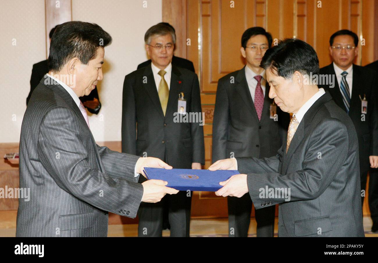 South Korean President Roh Moo-hyun, left, gives an appointment letter ...