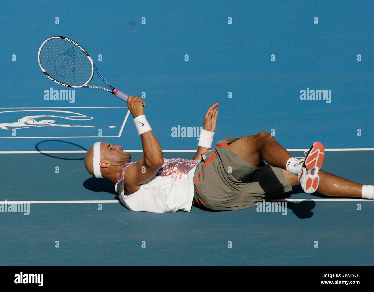 American James Blake takes a fall in his first round match against ...