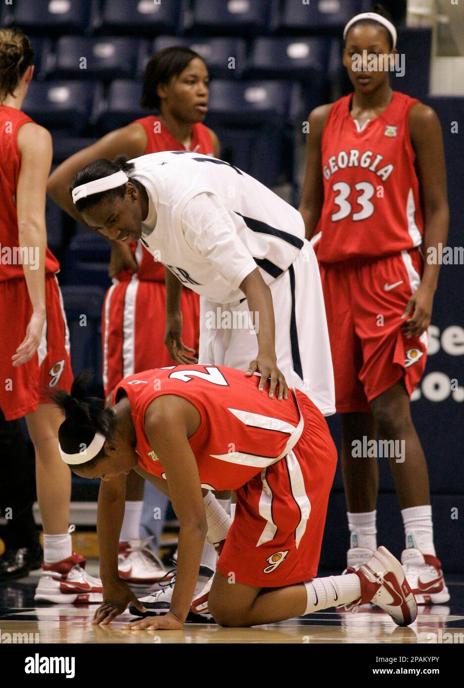 Xavier forward Amber Harris (11) checks on Georgia guard Christy ...