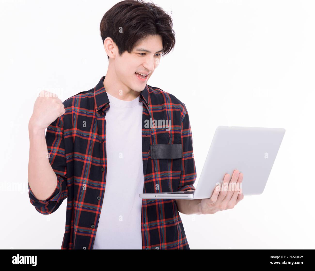 Happy young man holding on the laptop and showing yes gesture Stock ...