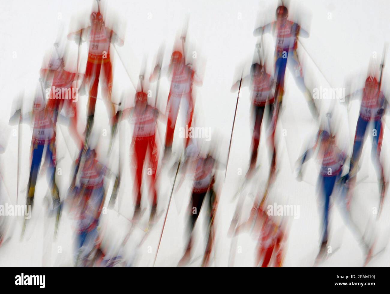 Biathlets, photographed with long time exposure, start during the women ...