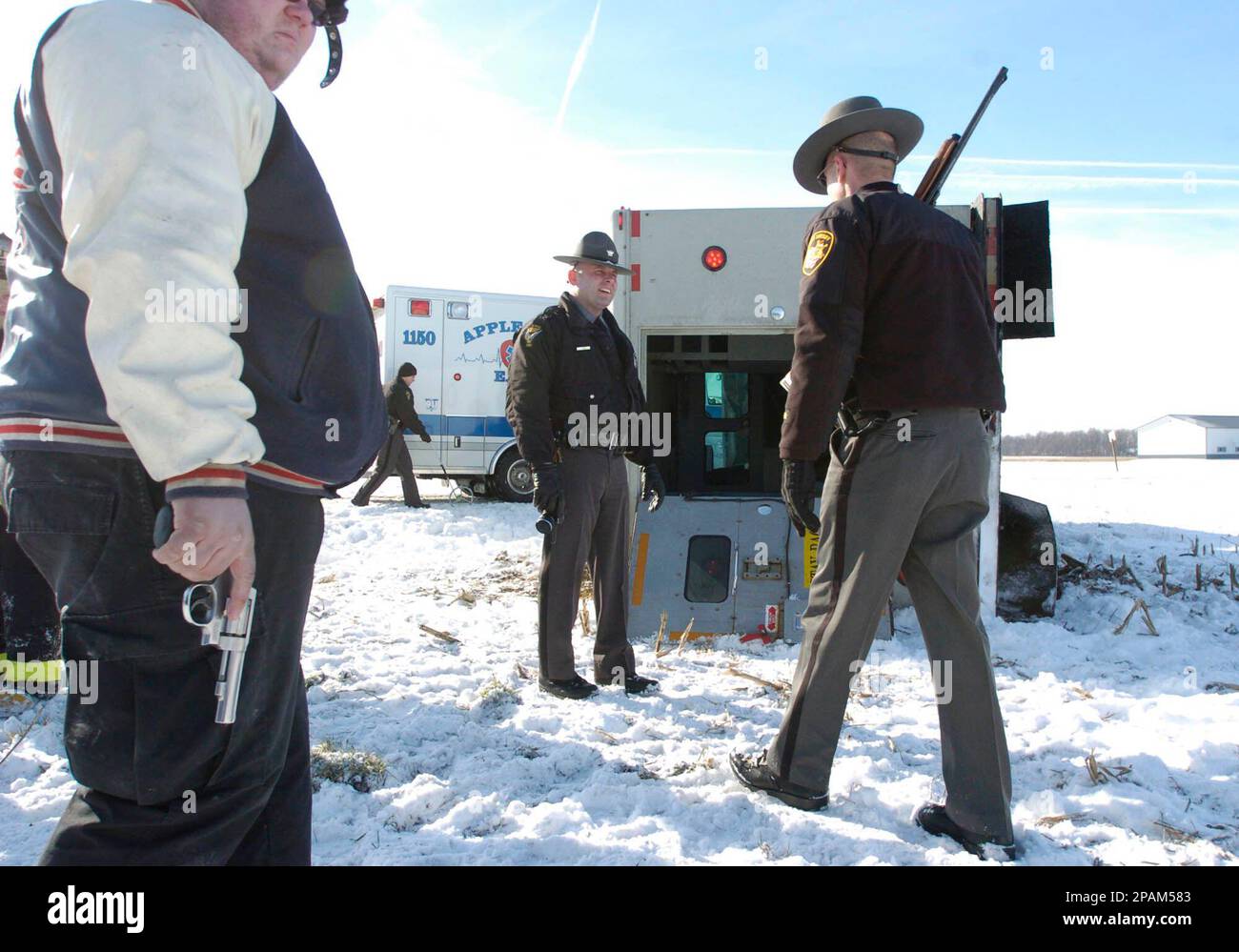 David Herndon, left, stands guard over the wrecked Brink's armored car ...