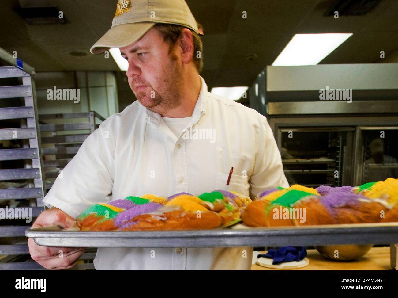 David Haydel, Jr. moves a tray of completed Mardi Gras King Cakes at ...