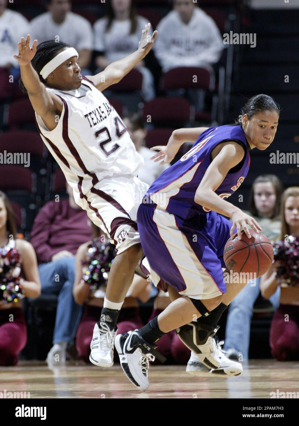 Texas A&M's Patrice Reado, left, draws a charge on Stephen F. Austin's ...