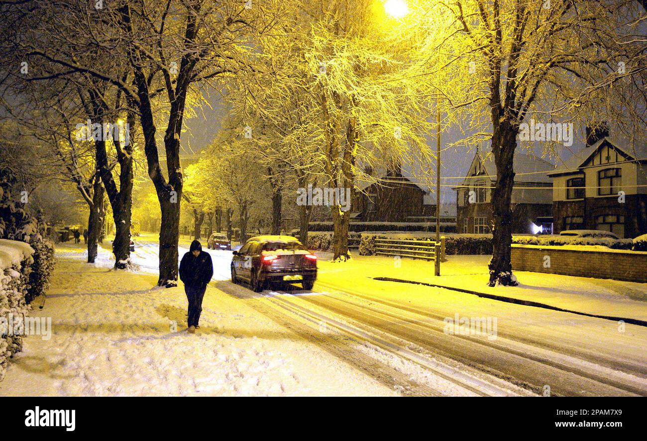 A woman braves the elements during a heavy snow fall in East Belfast ...