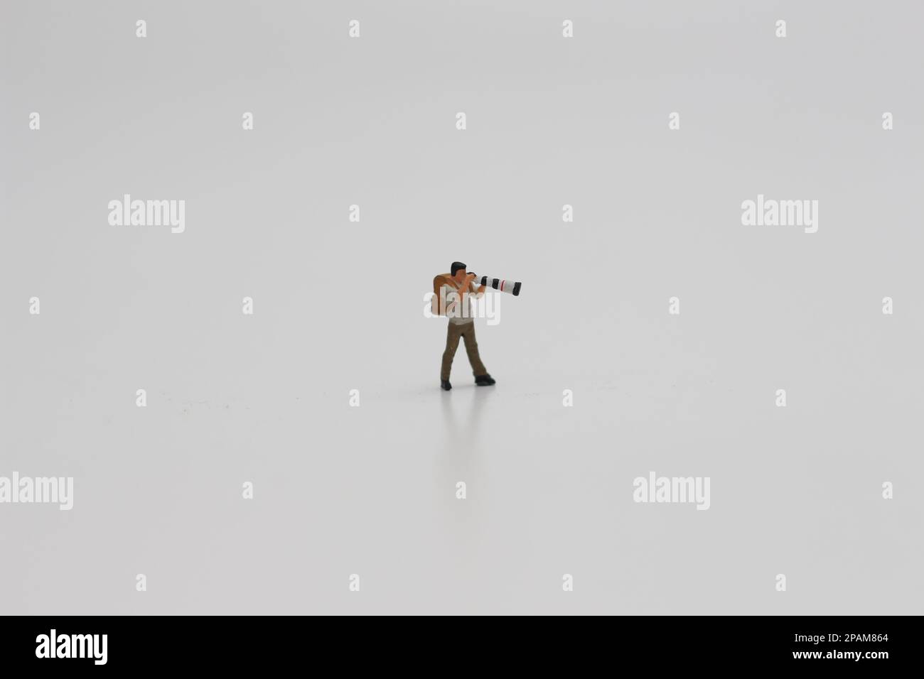 a close up of a miniature figure of a photographer with a camera and ...