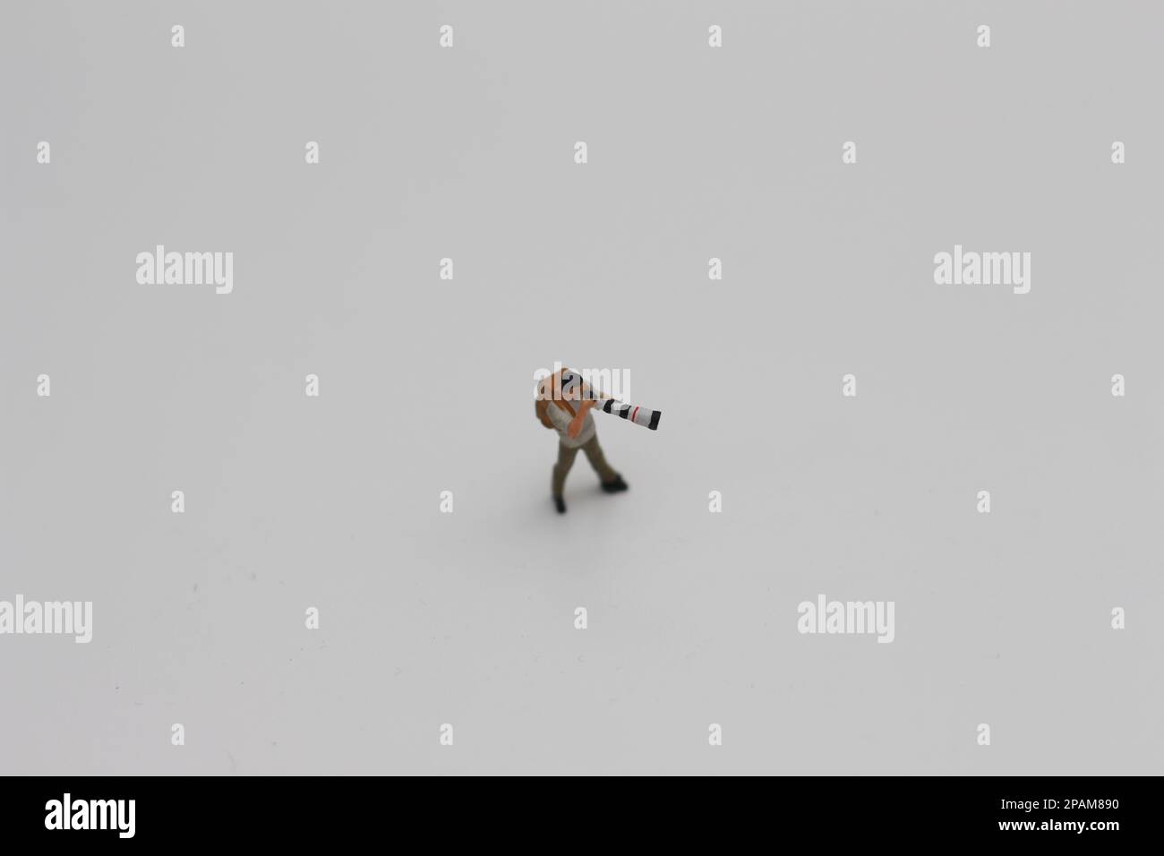 a close up of a miniature figure of a photographer with a camera and ...