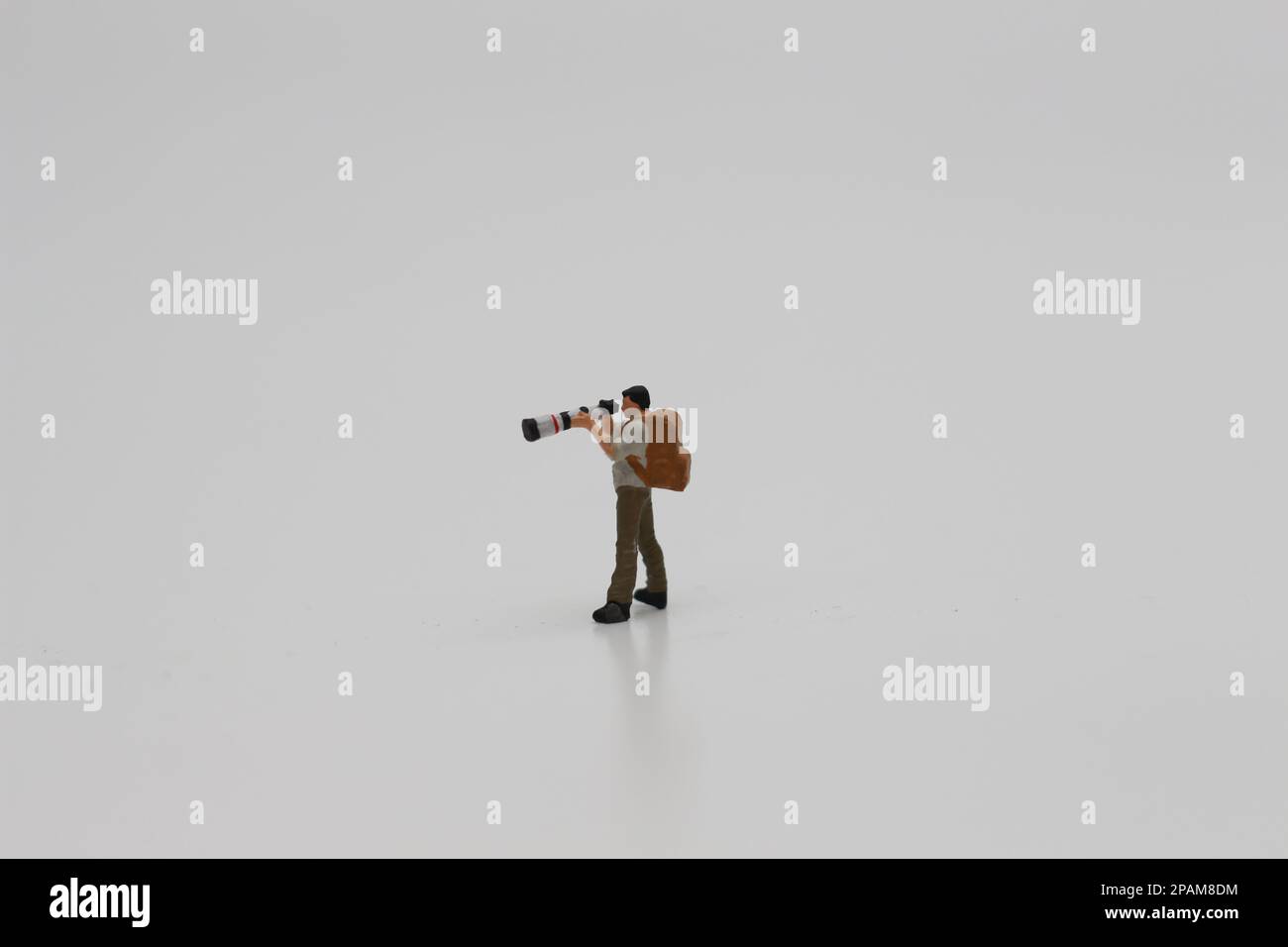 a close up of a miniature figure of a photographer with a camera and ...