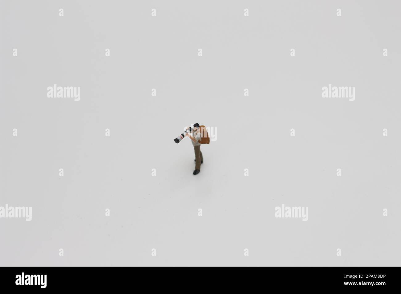 a close up of a miniature figure of a photographer with a camera and ...