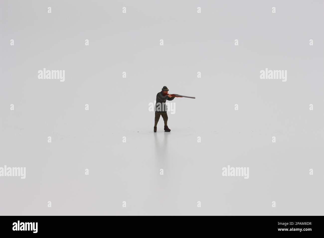 a close up of miniature figure of a hunter with a rifle isolated on ...