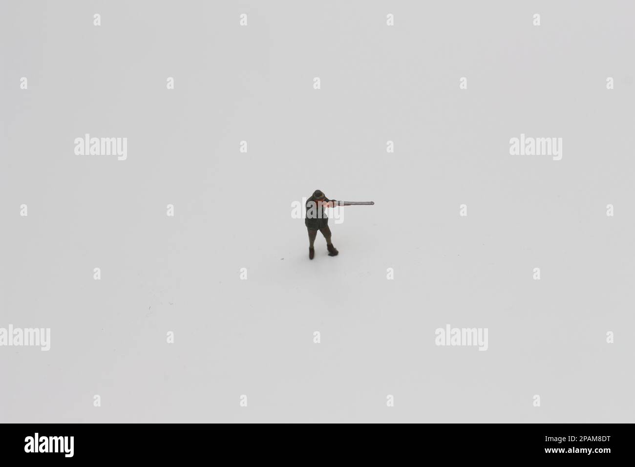 a close up of miniature figure of a hunter with a rifle isolated on ...