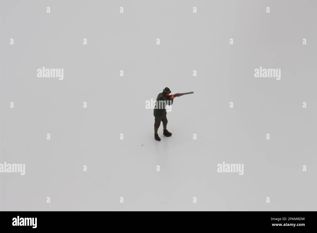 a close up of miniature figure of a hunter with a rifle isolated on ...