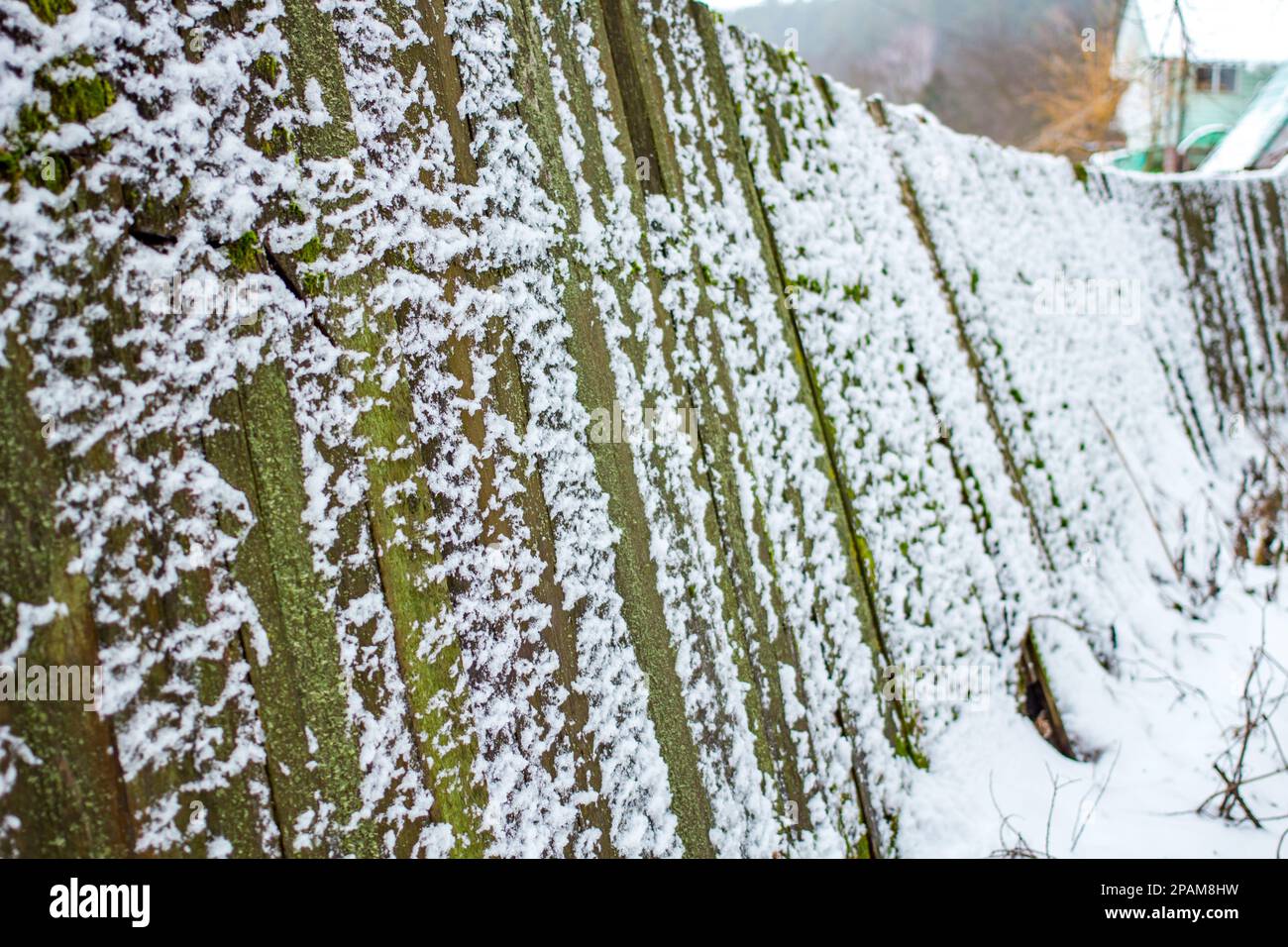 The old falling fence covered with snow Stock Photo - Alamy