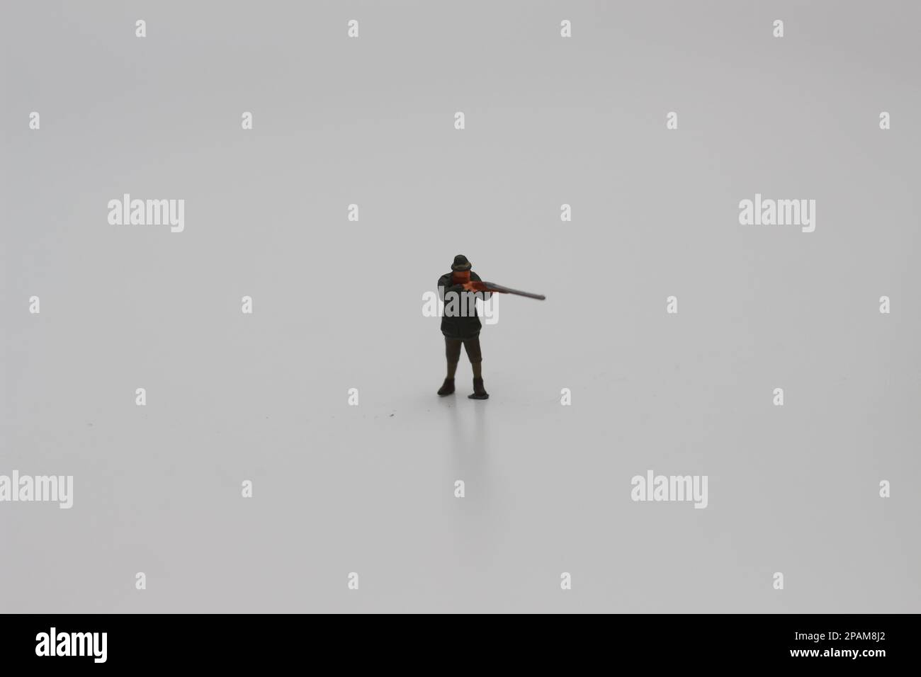 a close up of miniature figure of a hunter with a rifle isolated on ...