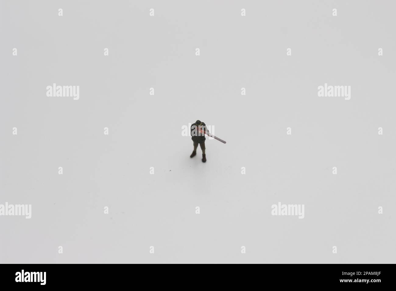 a close up of miniature figure of a hunter with a rifle isolated on ...