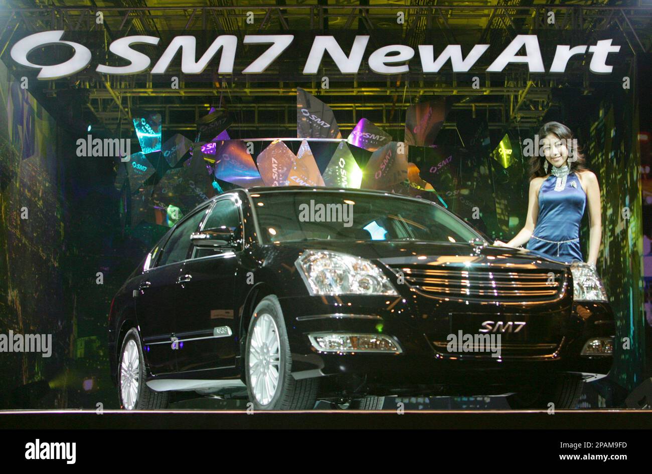 A South Korean model poses next to Renault Samsung Motors's new model ...