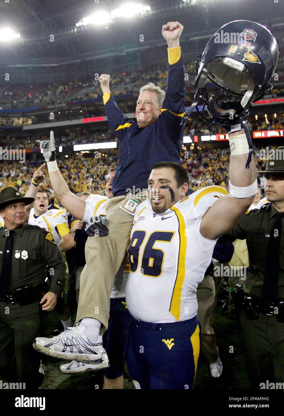 West Virginia head coach Bill Stewart is carried off the field by his ...