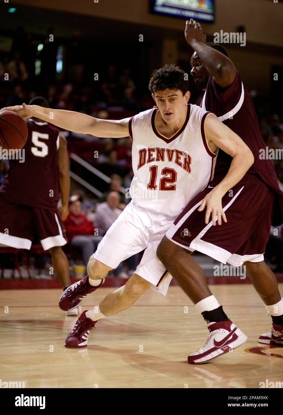 Denver center Adam Tanner (12) drives past Louisiana Monroe forward ...