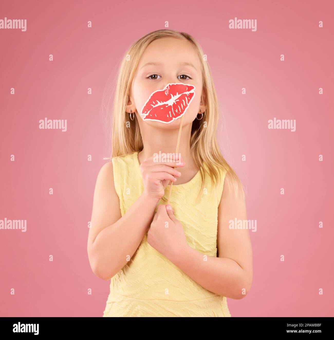 Portrait, children and lips with a girl on a pink background in studio ...
