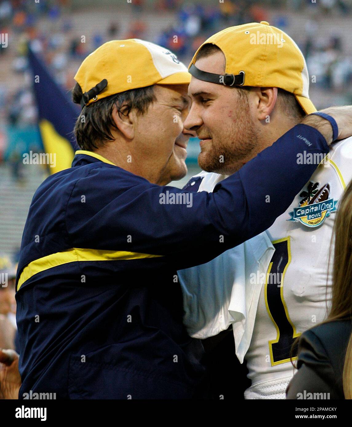 Michigan head coach Lloyd Carr, left, hugs quarterback Chad Henne after ...