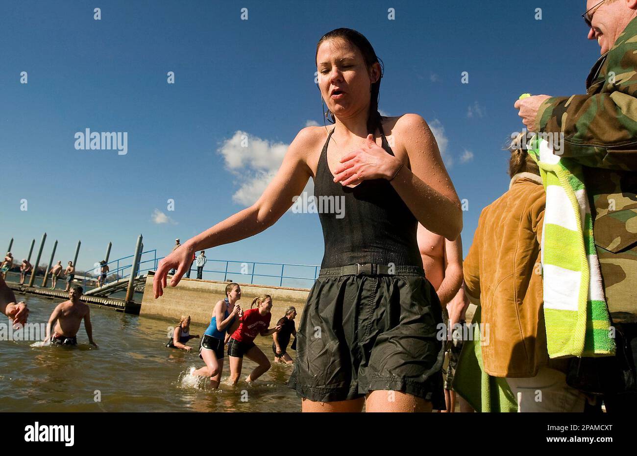 Catherine Godbey exits the frigid water along with other residents of ...