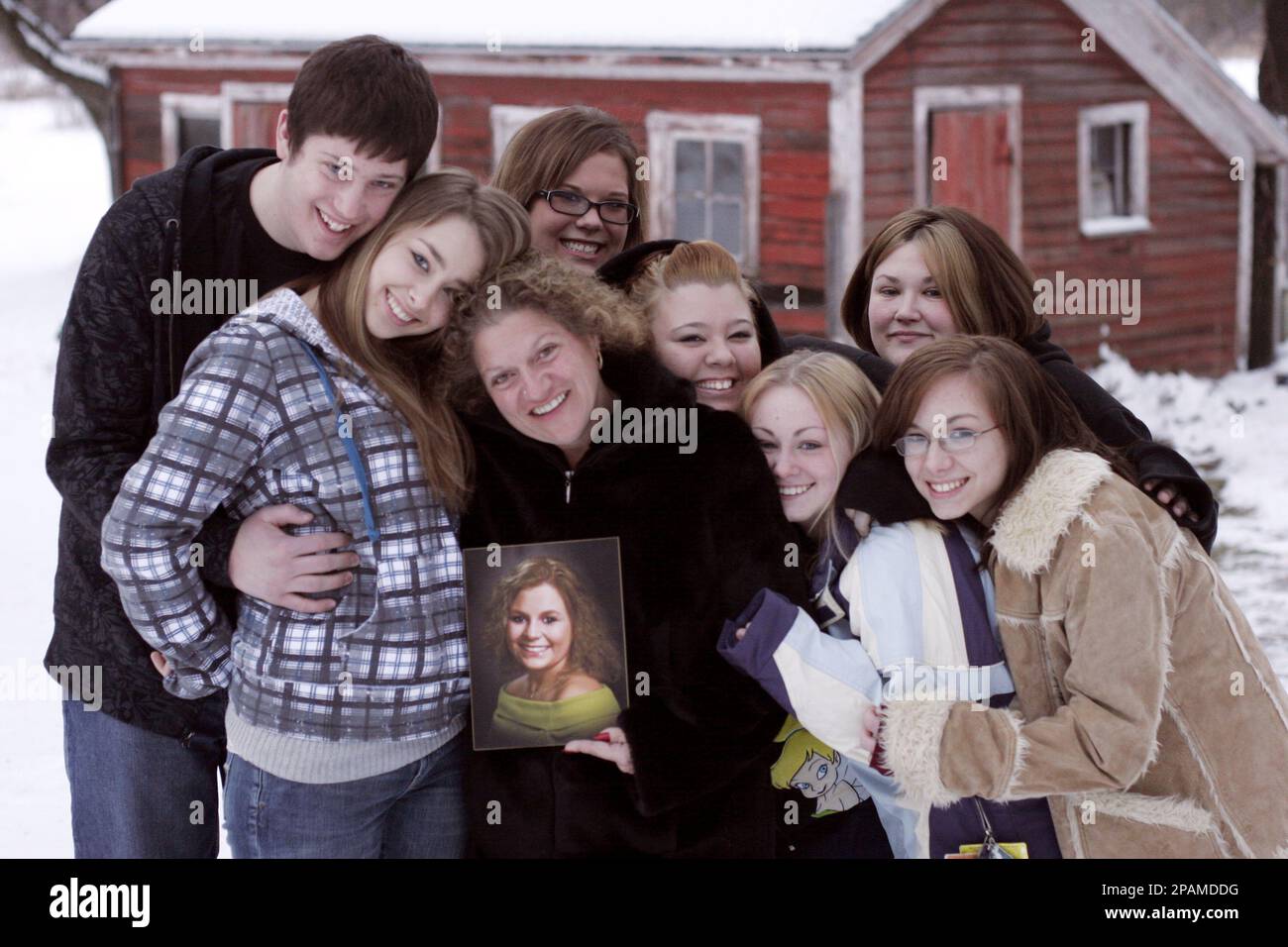 Deborah Fowler, center, 47, of Marion Springs, holds a photo of her ...